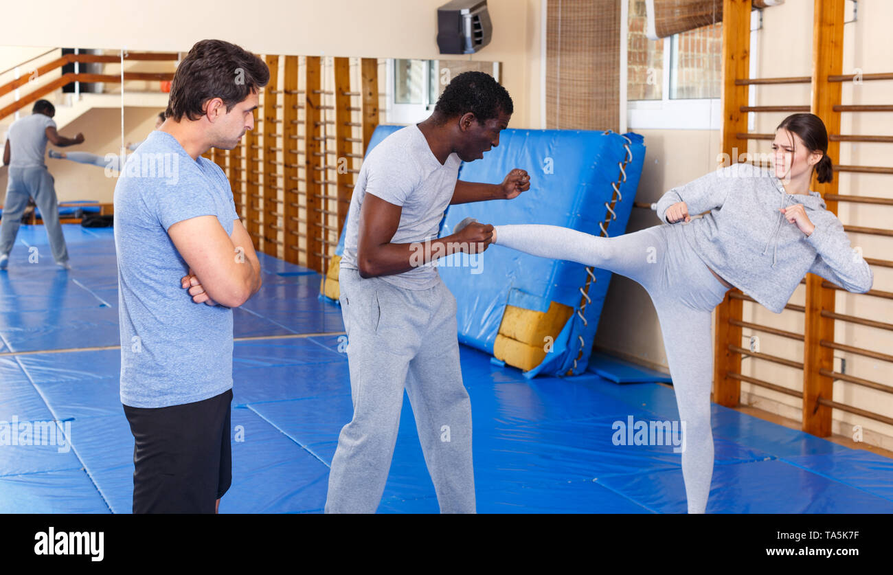 Young people practicing in pair self-defence movements with male ...