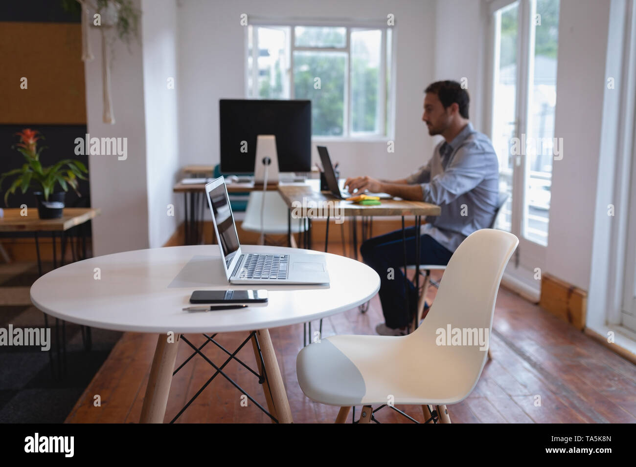 Attentive male executive using laptop hi-res stock photography and ...
