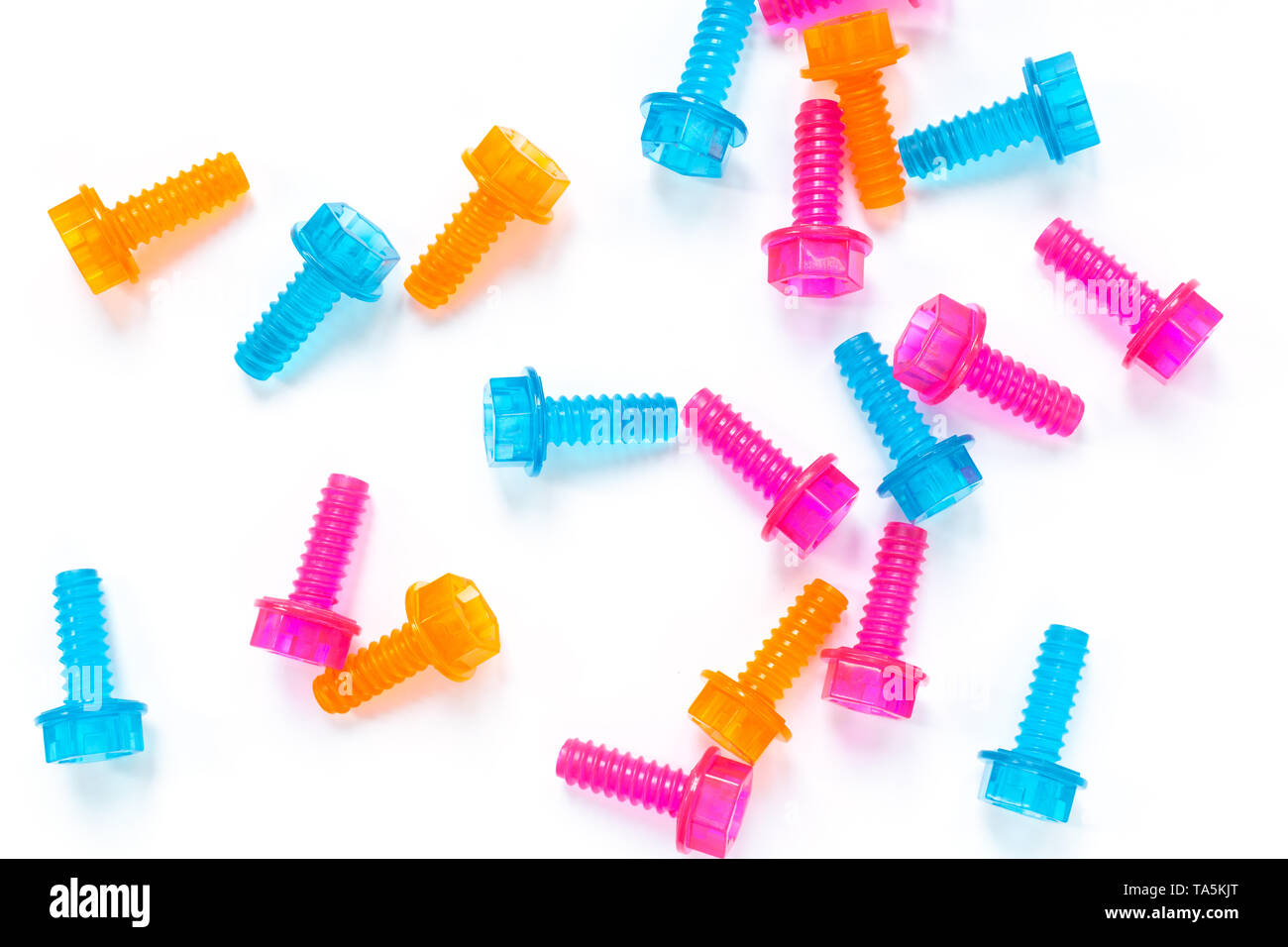 Colored neon translucent plastic toy bolts on white background. Flat ...