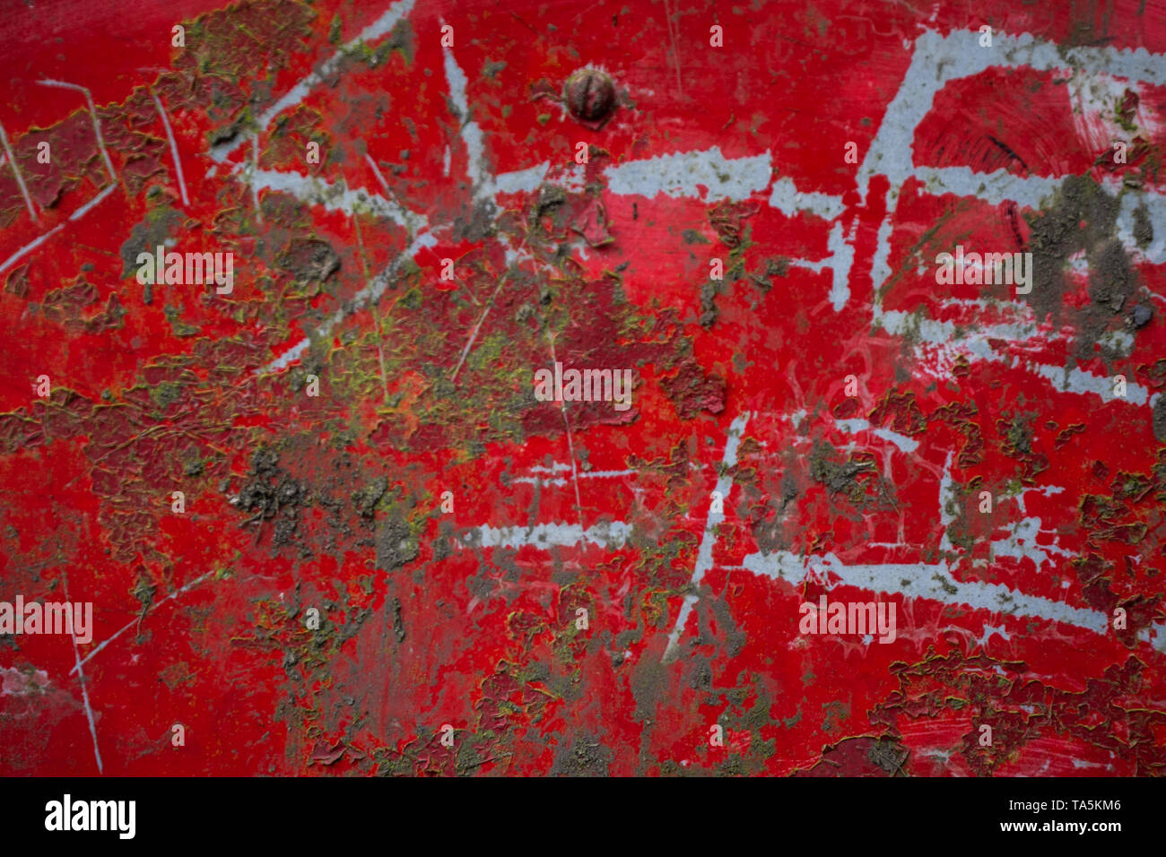 The texture of red metal surface. Pattern of sign on wall. close up ...