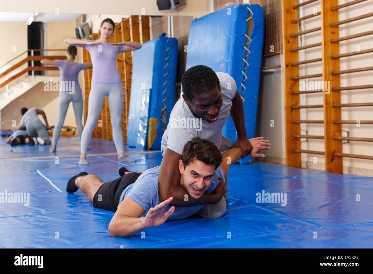Two young men practicing self defense techniques in sports club Stock ...