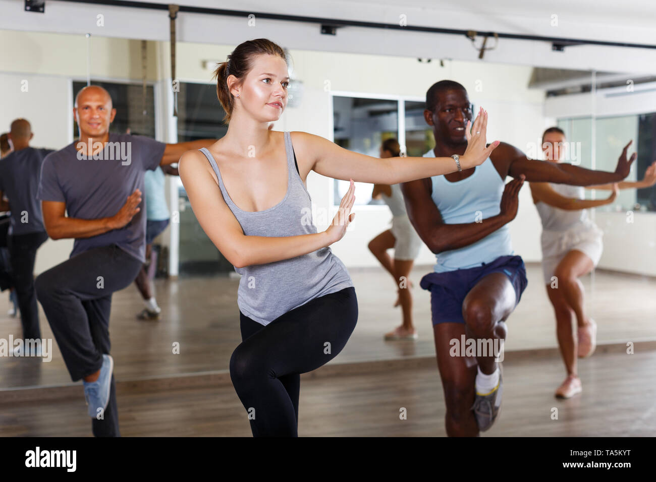 positive dancing people practicing vigorous swing in dance studio Stock ...