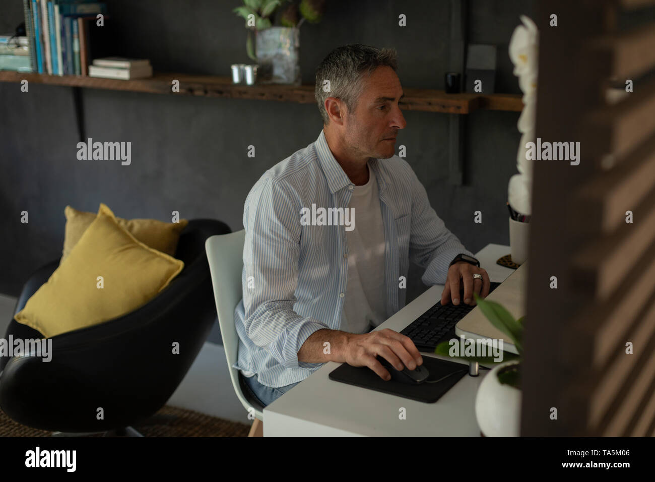 Relaxed man using computer in hi-res stock photography and images - Alamy