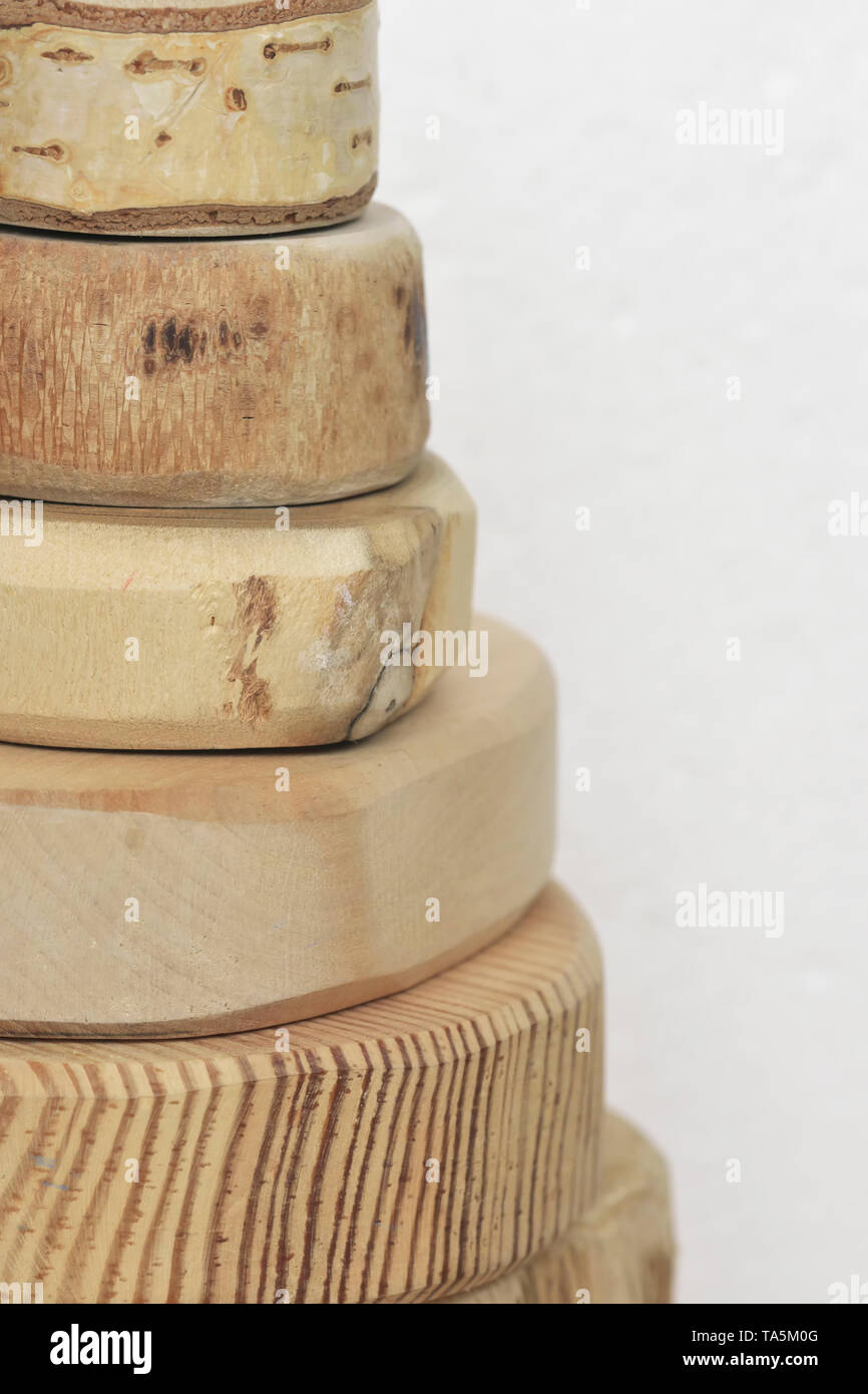 A wooden pyramid of treated wood on a white background with a place for ...