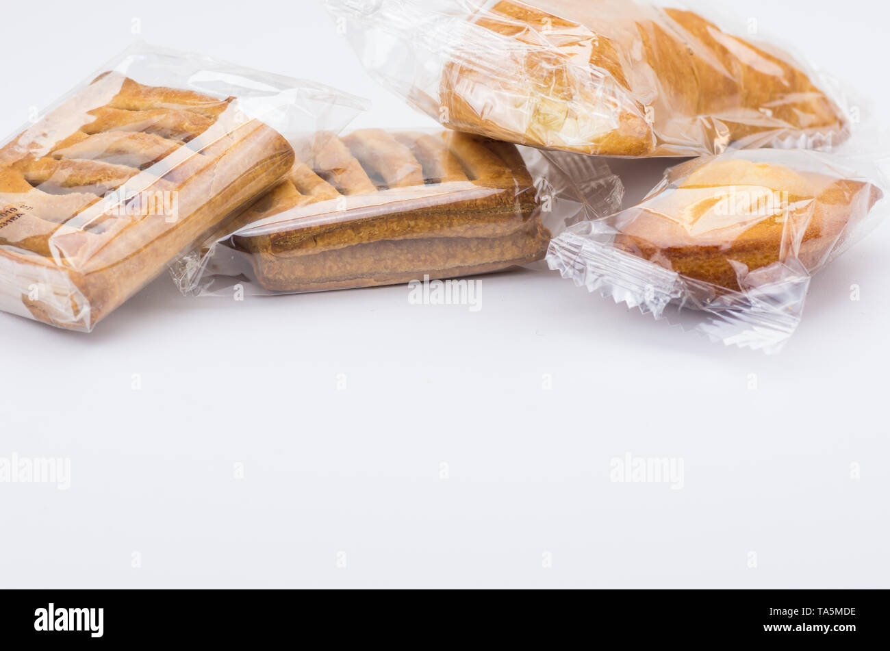 pre packaged snacks and pastries on a blank surface Stock Photo - Alamy