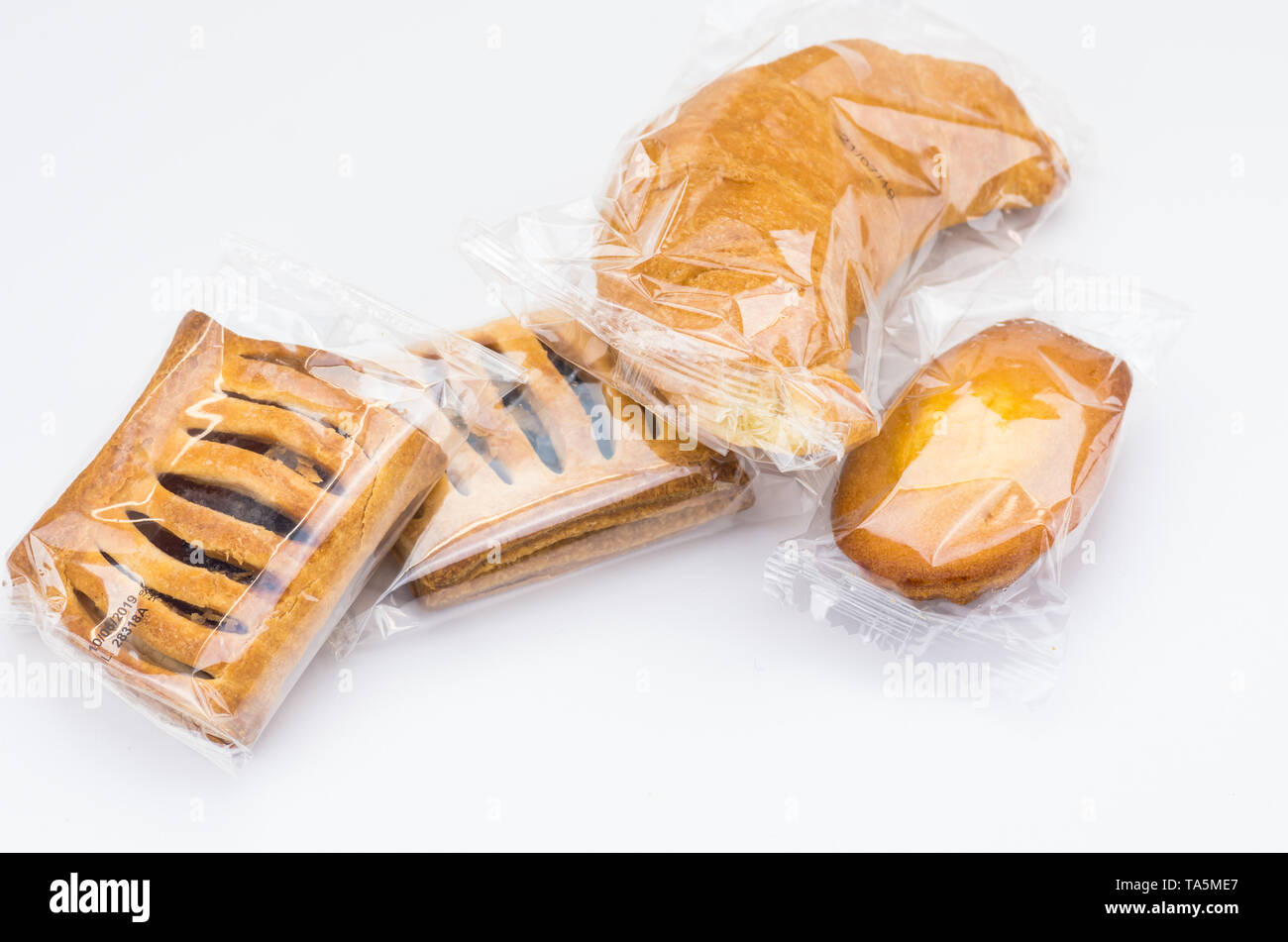 pre packaged snacks and pastries on a blank surface Stock Photo - Alamy