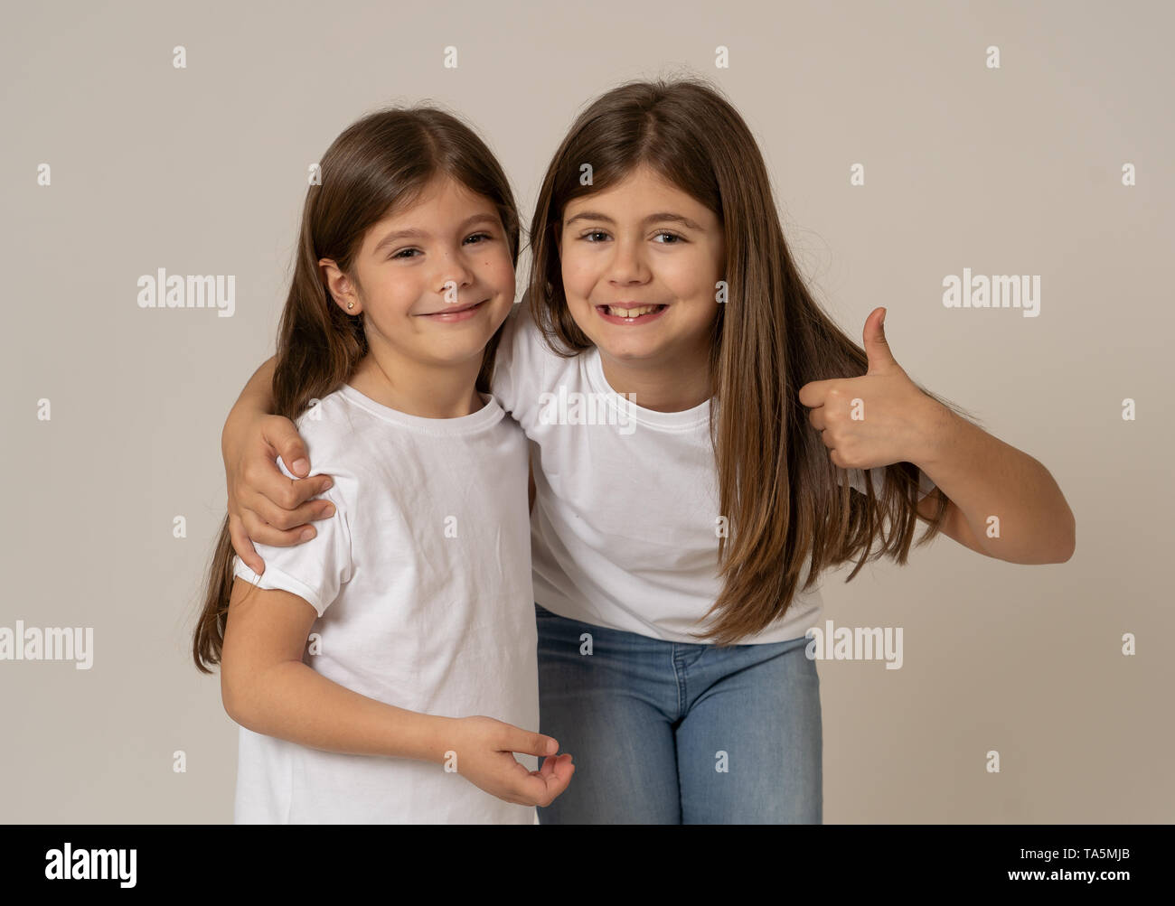 Cute portrait of two cheerful siblings girls sisters having fun ...