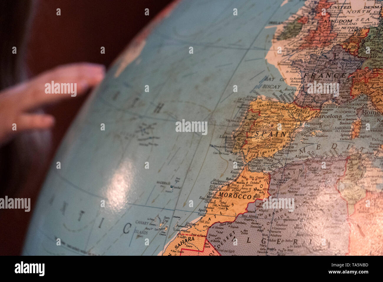 Hand touching earth globe detail Stock Photo - Alamy