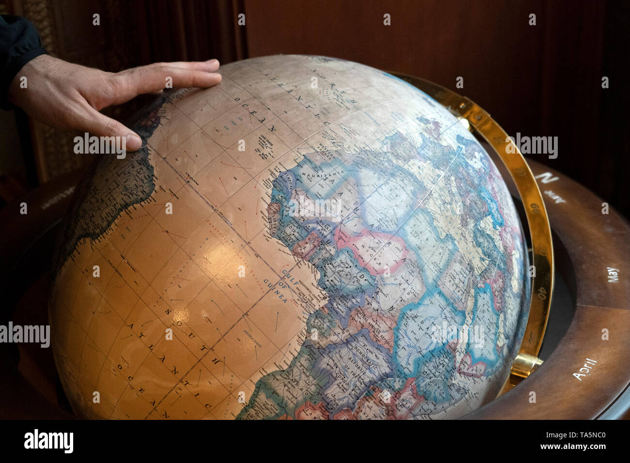 Hand touching earth globe detail Stock Photo - Alamy