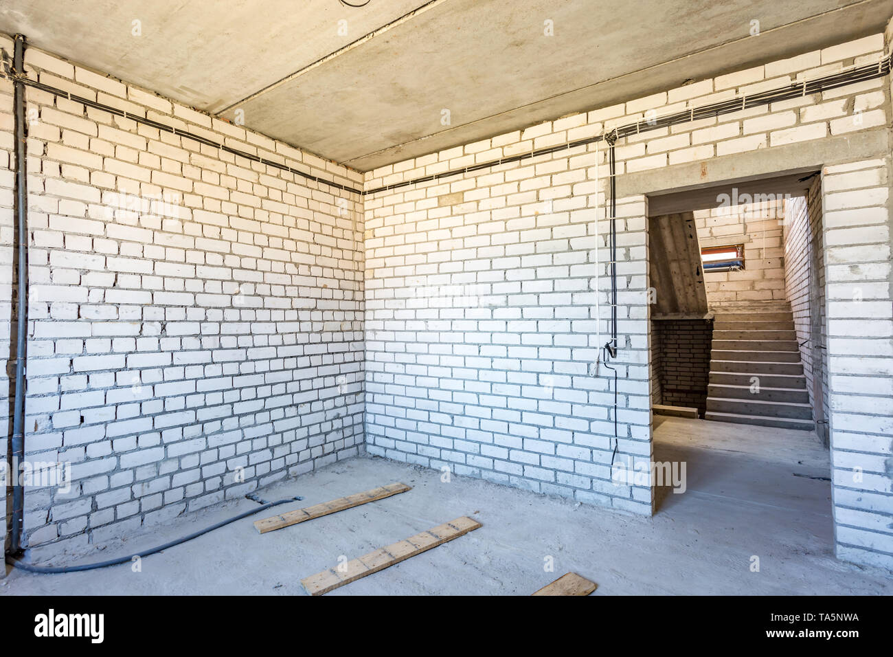 empty interior in house without repair with white silicate brick walls ...