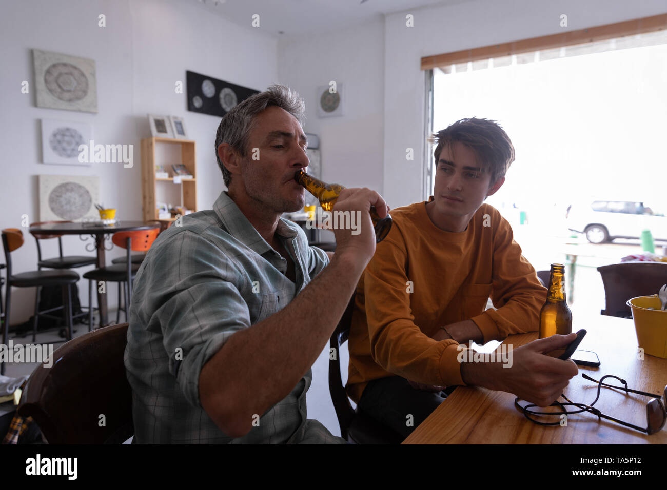 Father and son drinking beer Stock Photo - Alamy