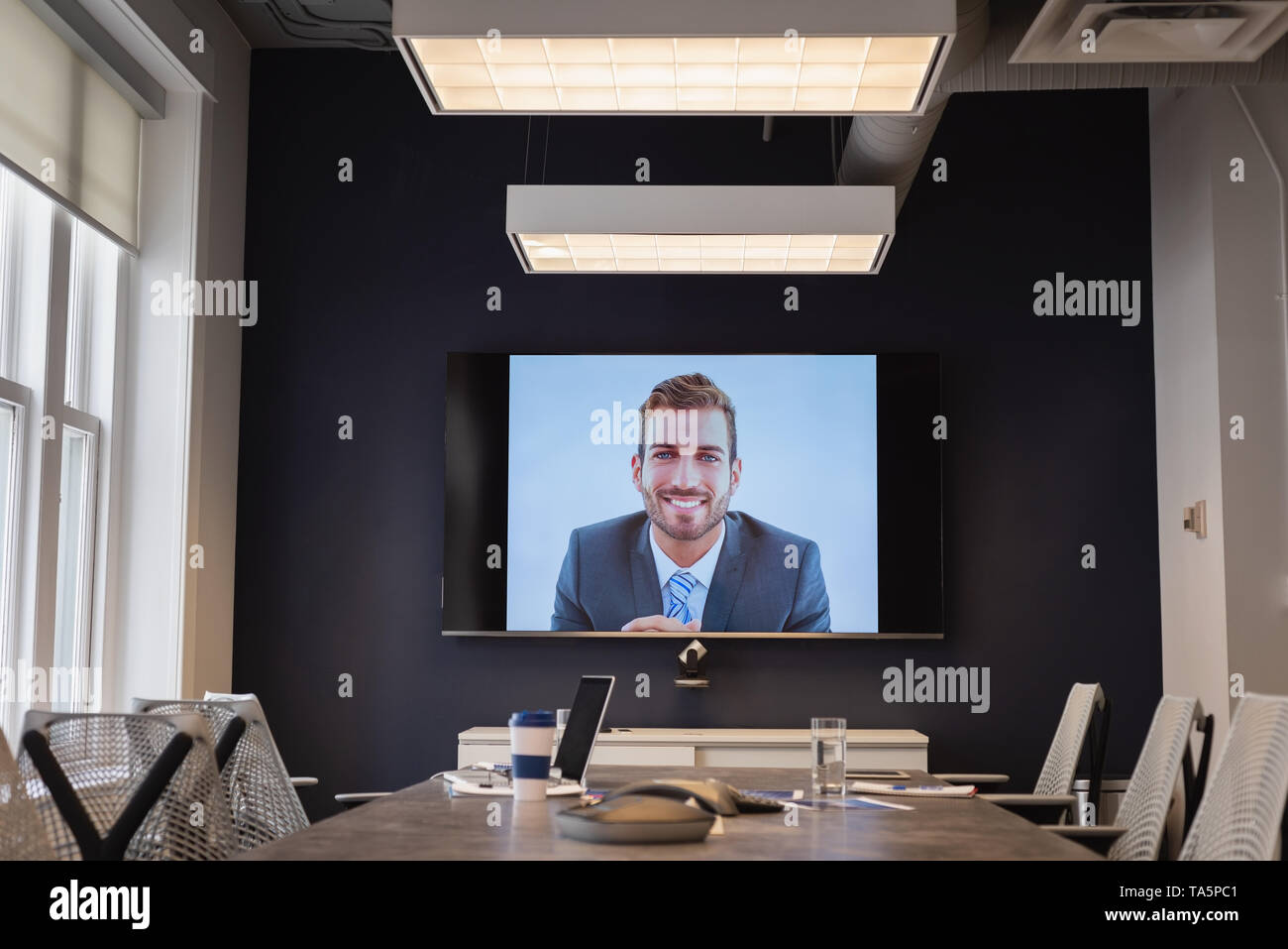 Businessman in video call waiting for colleagues in conference room ...