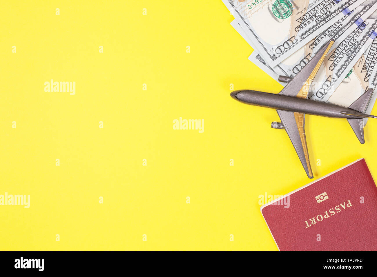One hundred dollar bills, airplane, headphones, foreign passport on ...