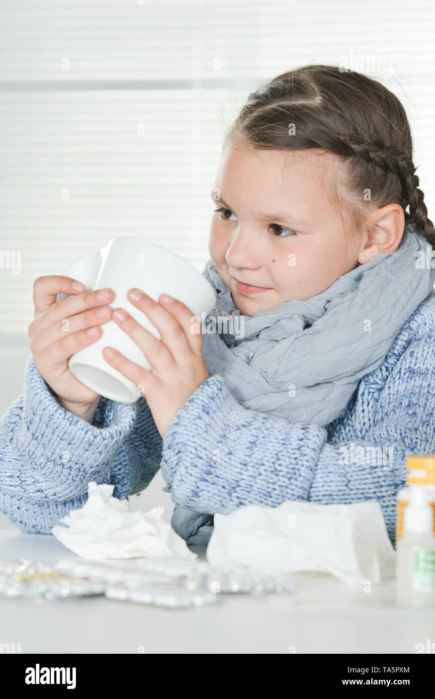Portrait of cute sick girl with medicines Stock Photo - Alamy
