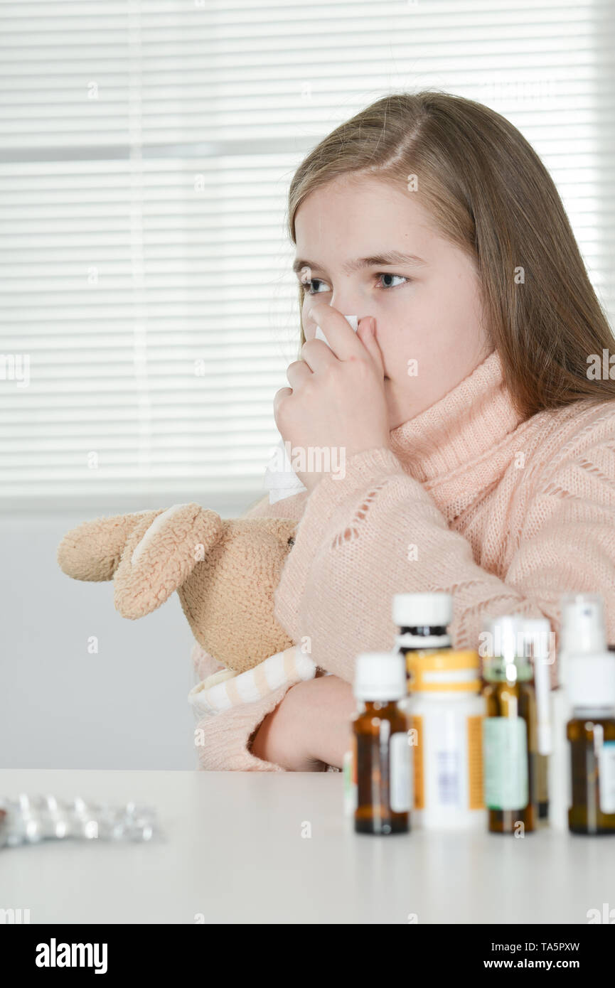 Portrait of cute ill girl taking medicine at home Stock Photo - Alamy