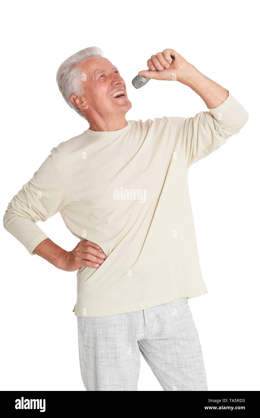Portrait of senior man singing with microphone on white background ...