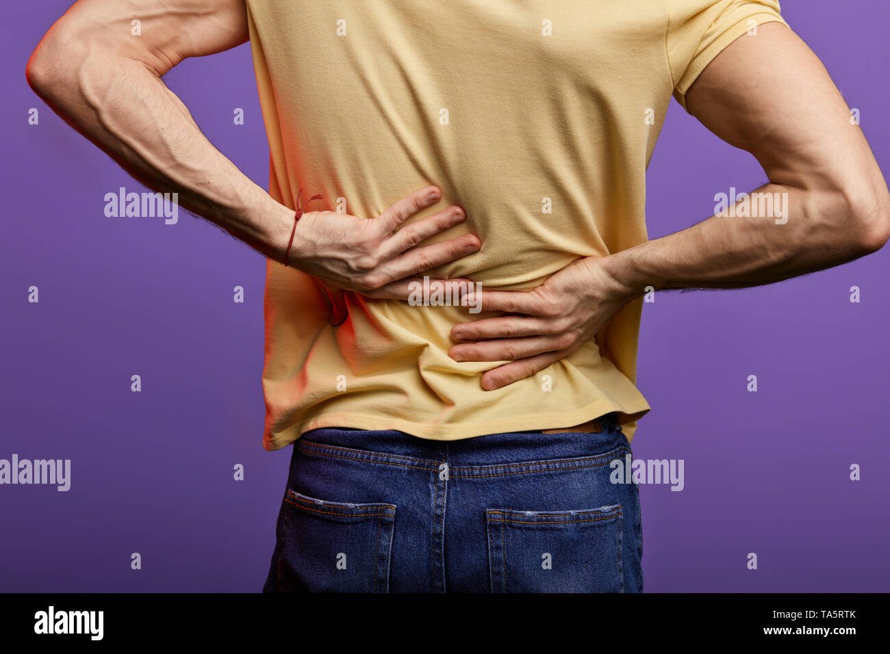 man touching his back, guy has disk peoblems in his back. close up ...