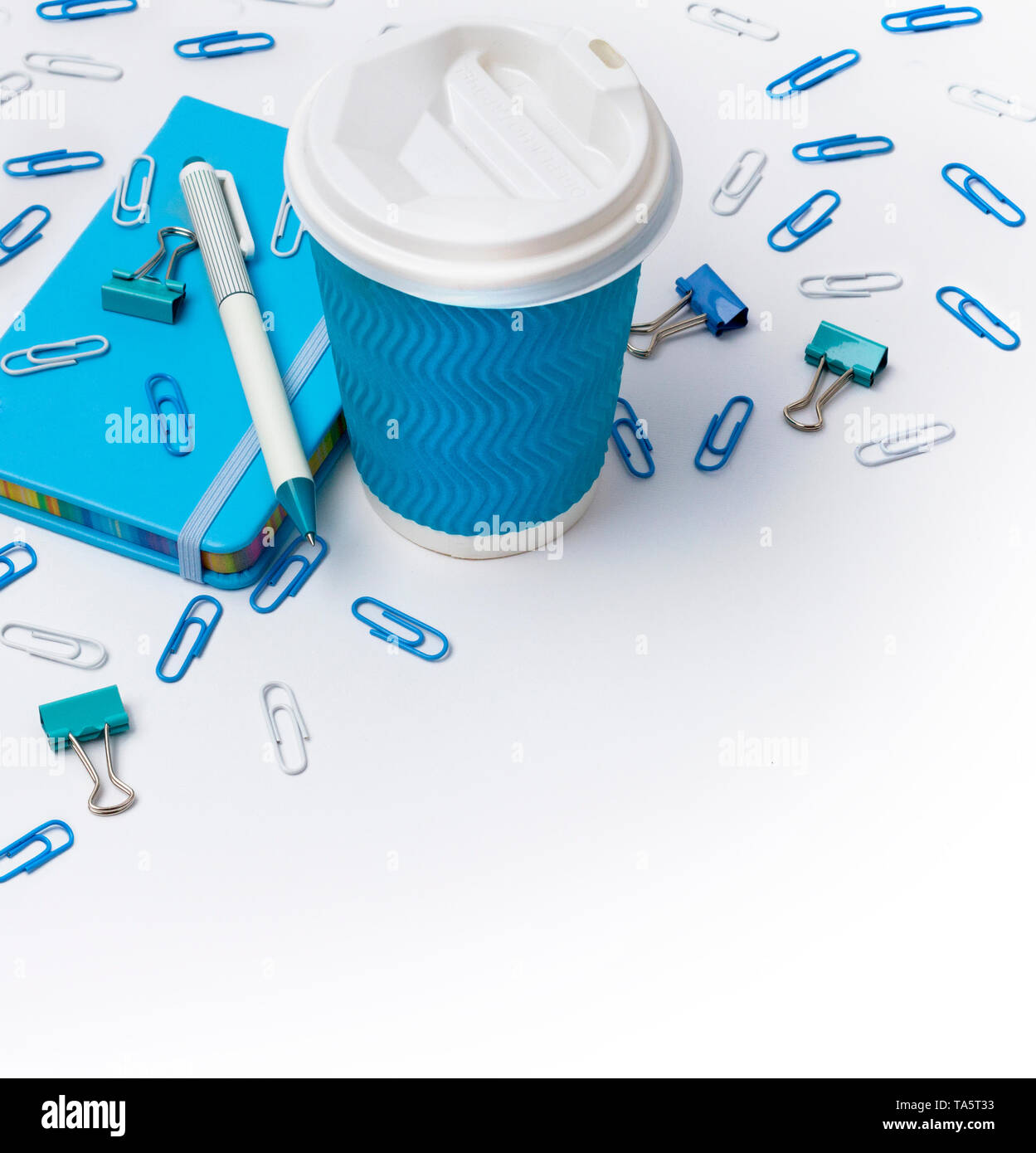 Blue office supplies. Paper coffee cup, pen and notepads isolated on ...