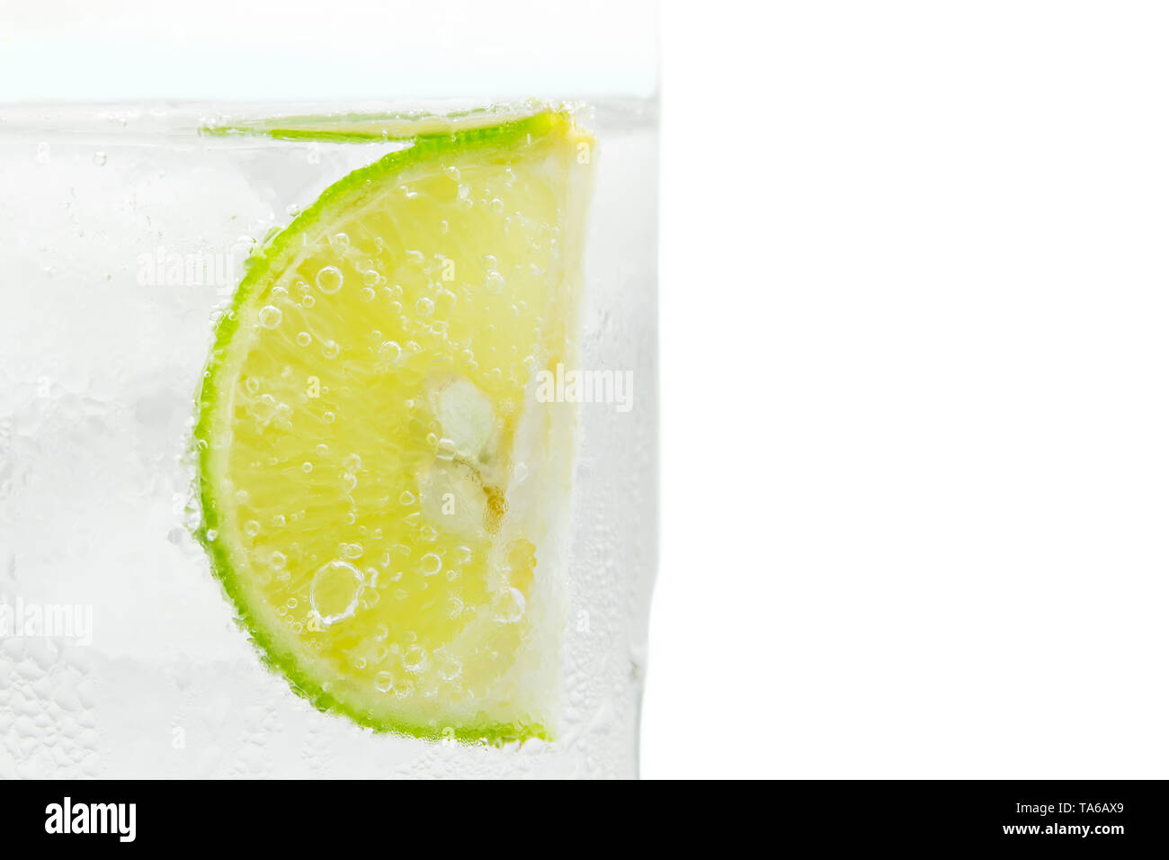 Close up slice of lime in glass sprakling water isolated Stock Photo ...