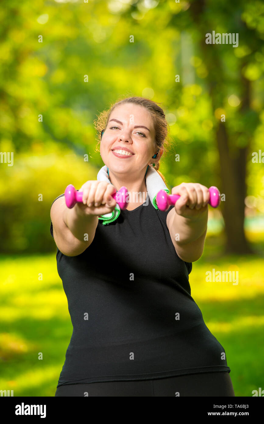 overweight woman doing her exercise in the park, exercise with ...