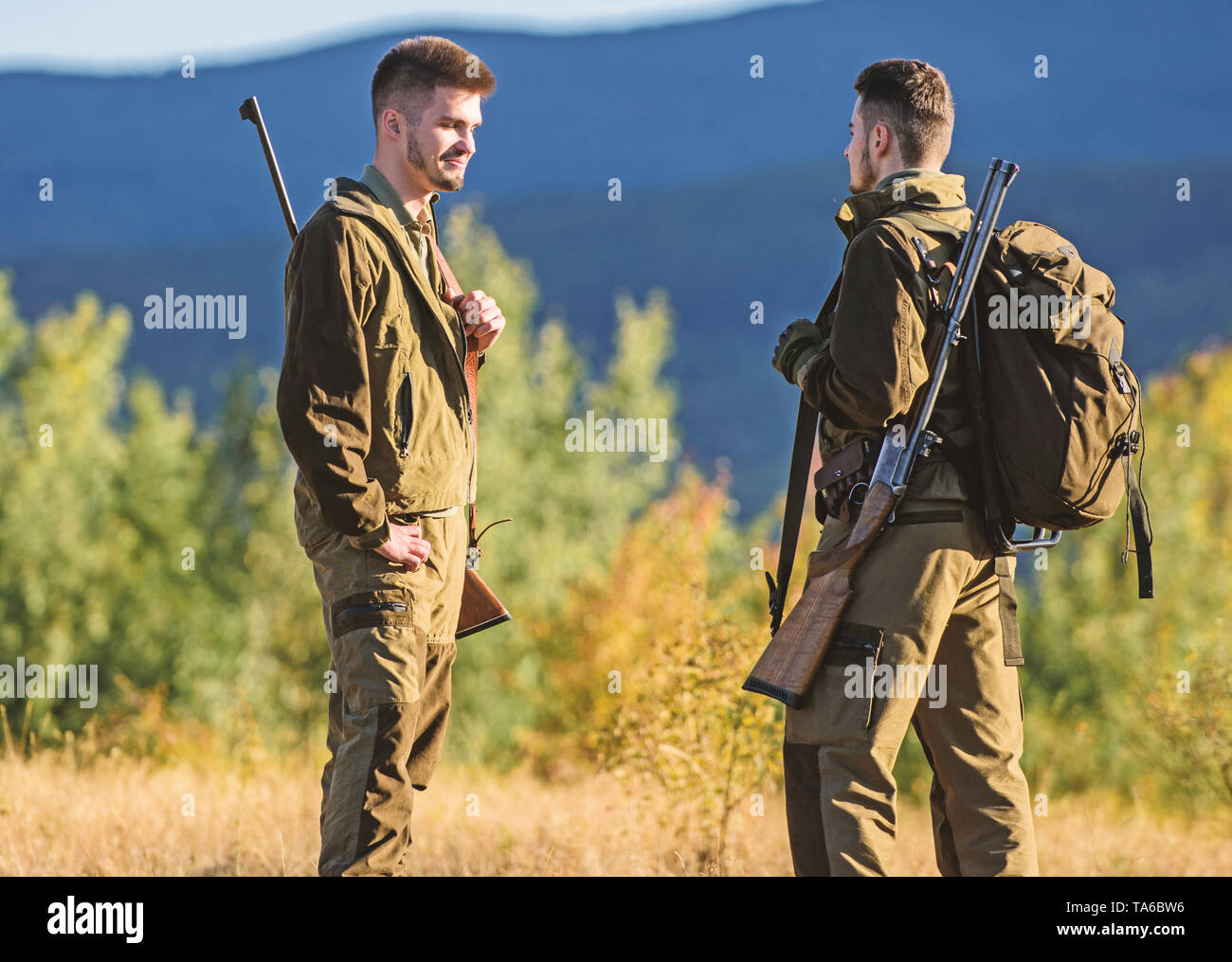 Man hunters with rifle gun. Boot camp. Friendship of men hunters. Army ...