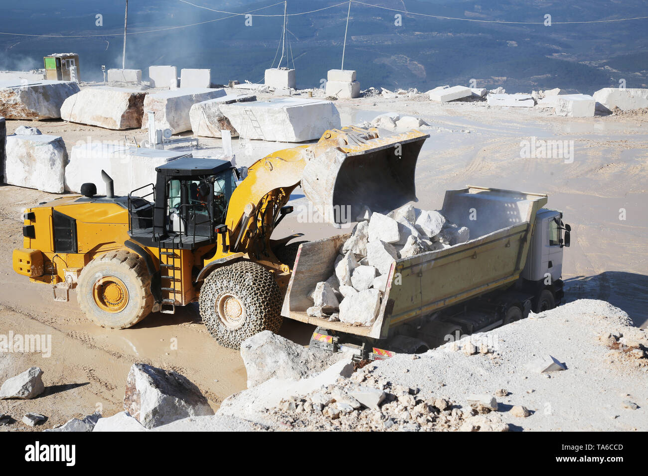 A big loader machine working on marble quarry. A loader loading marble ...