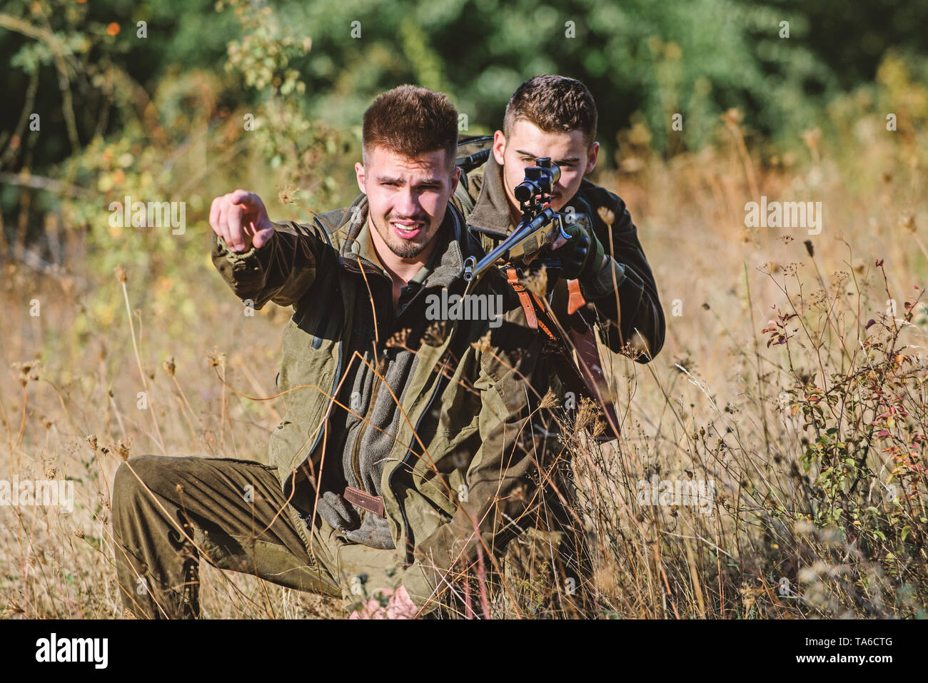 Activity for real men concept. Hunters with rifles in nature ...