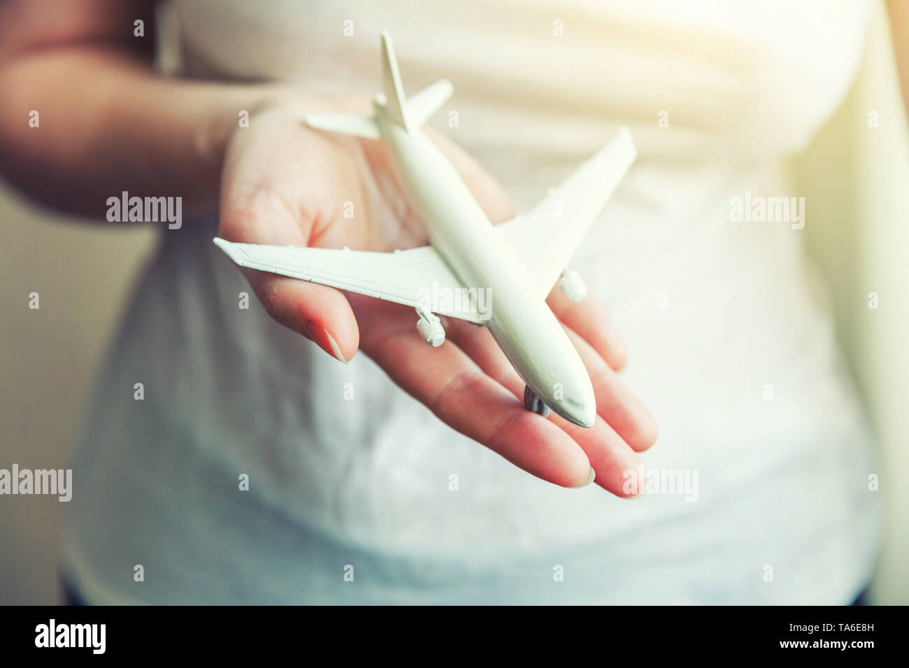 Female woman hands holding small toy model plane. Travel by plane ...