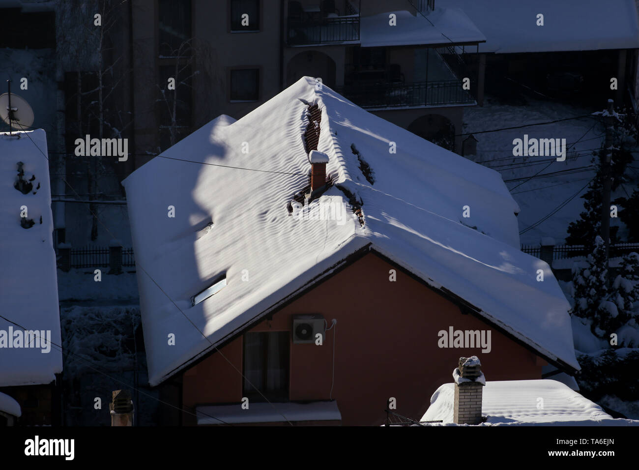 Beautiful winter view of houses and buildings with roofs covered with ...