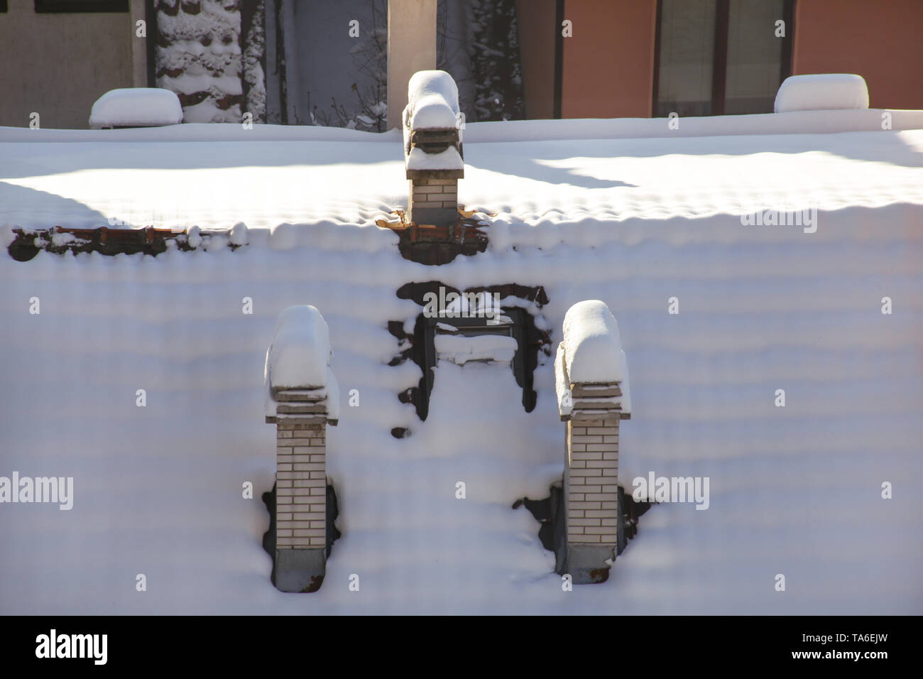 Beautiful winter view of houses and buildings with roofs covered with ...