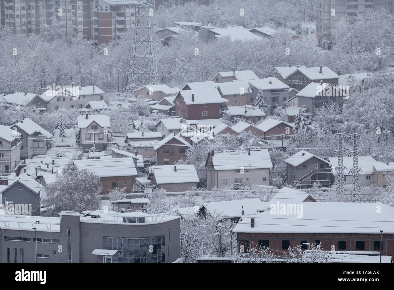 Beautiful winter view of houses and buildings with roofs covered with ...