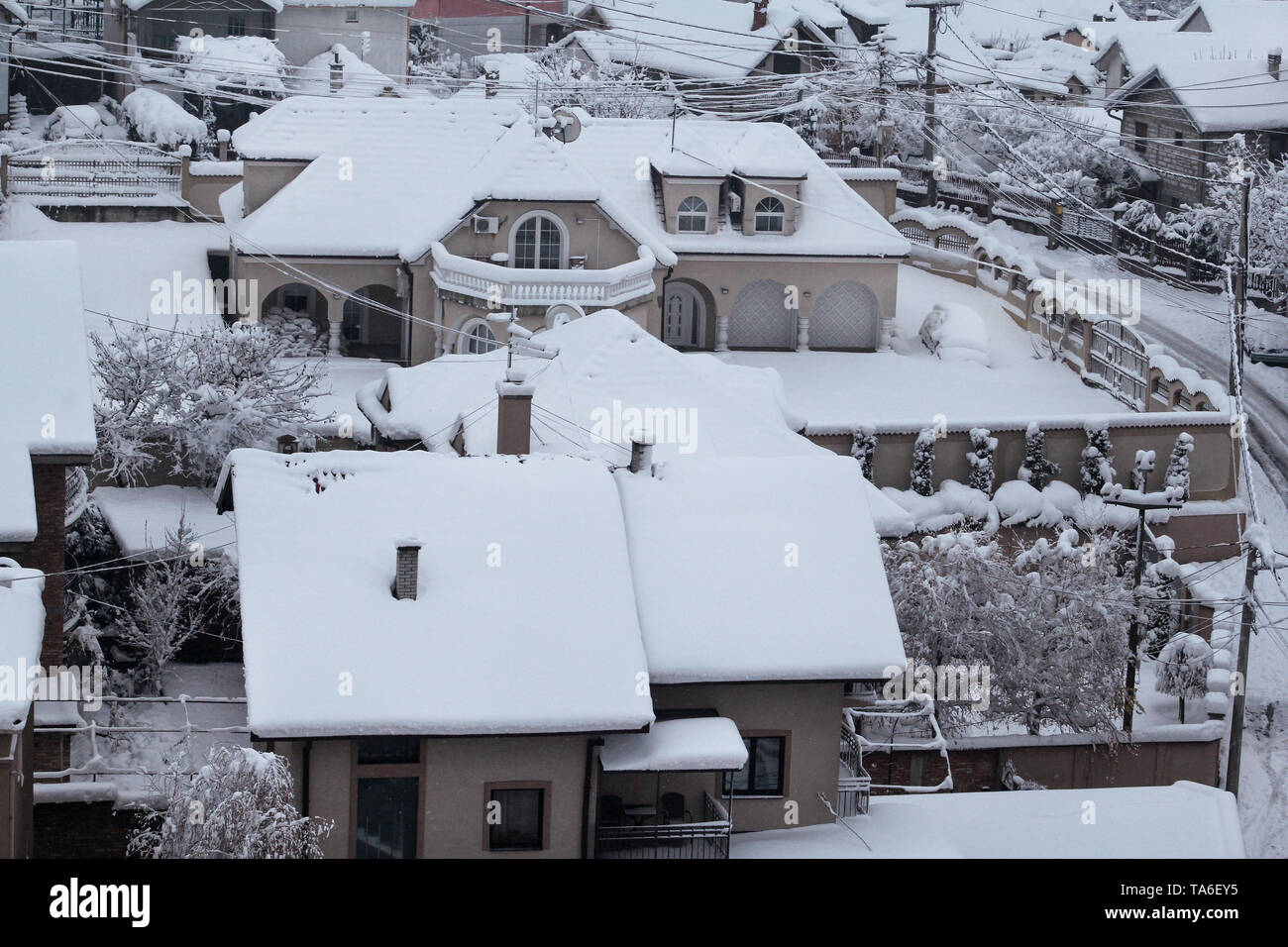 Beautiful winter view of houses and buildings with roofs covered with ...