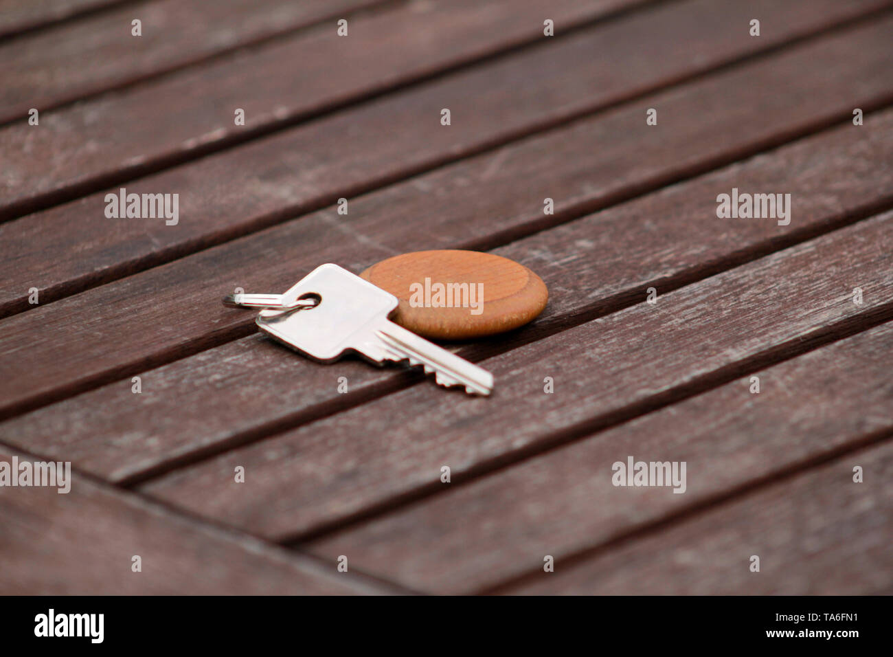 Hotel suite key with wooden fob for room on wood table. Room key on ...