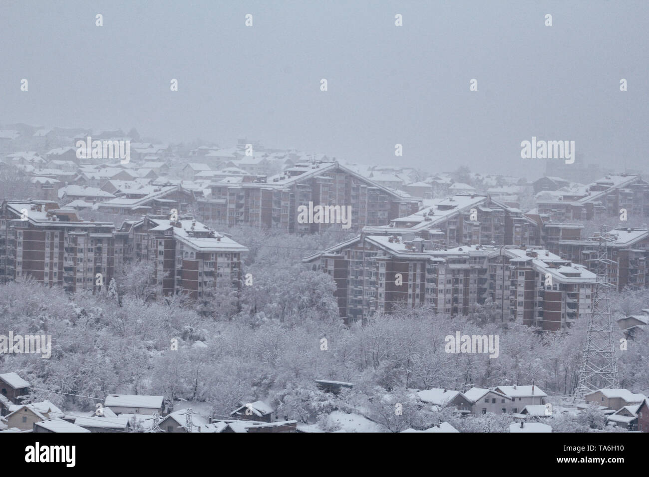Beautiful winter view of houses and buildings with roofs covered with ...