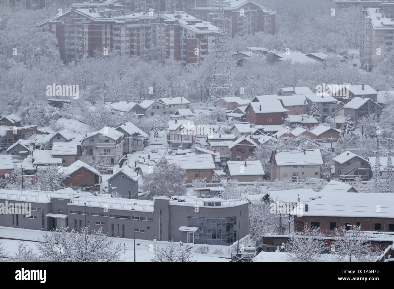 Beautiful winter view of houses and buildings with roofs covered with ...
