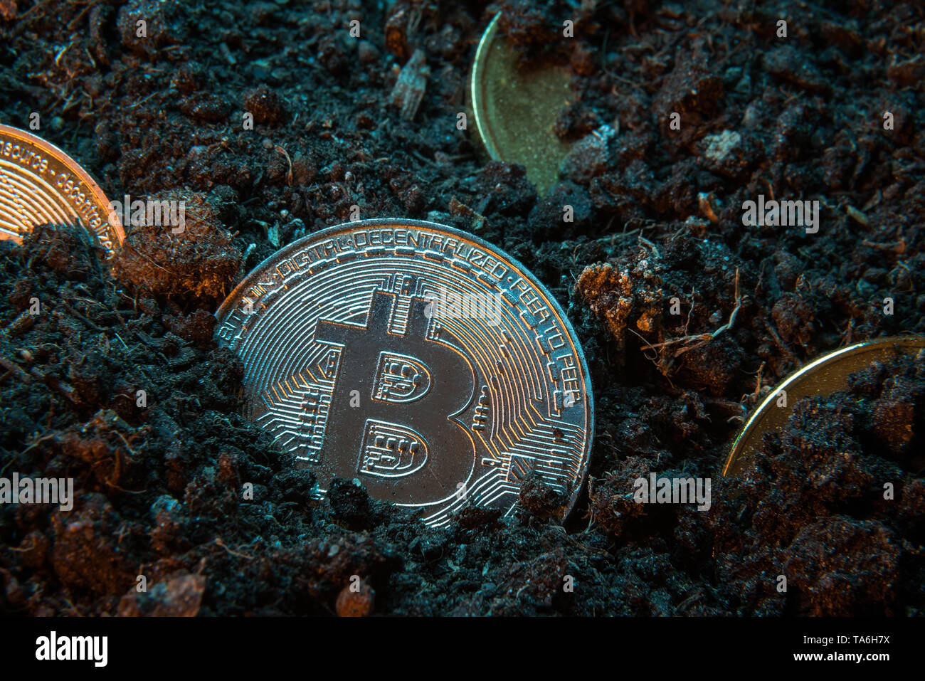 Mining crypto currency - Bitcoin. Online money coin in the dirt ground ...