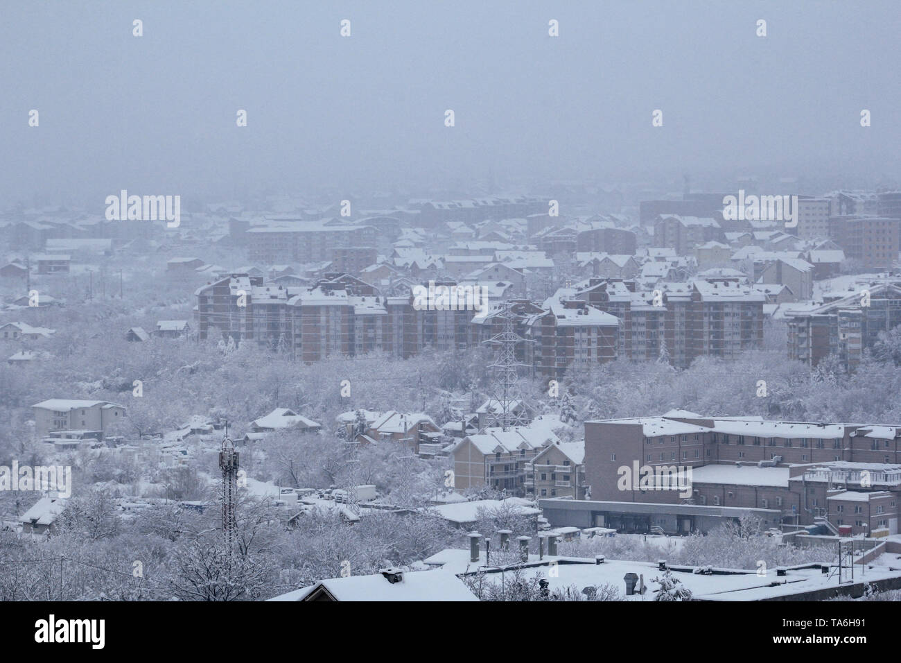 Beautiful winter view of houses and buildings with roofs covered with ...