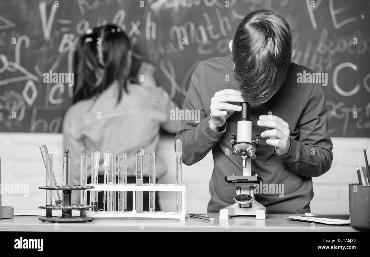 Little boy and girl in lab. biology experiments with microscope. Little ...
