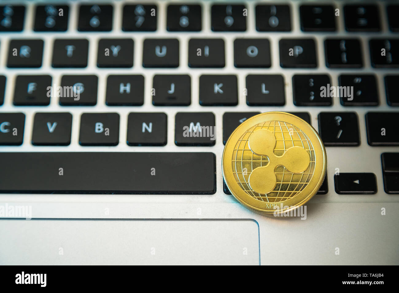 Circle Ripple coin on top of computer keyboard buttons. Digital ...