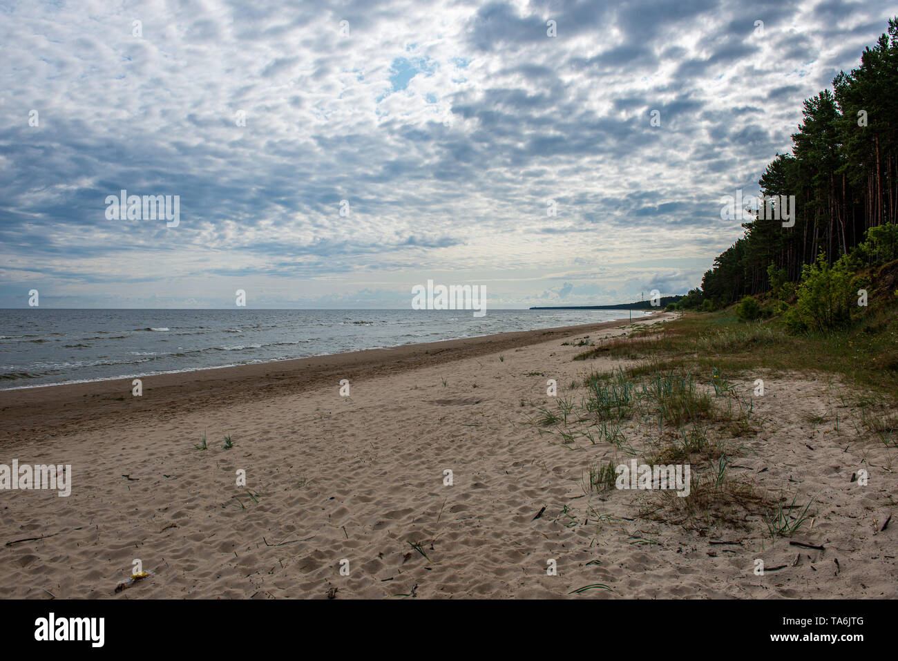 empty sea beach in summer with waves and broken clouds. white sand ...