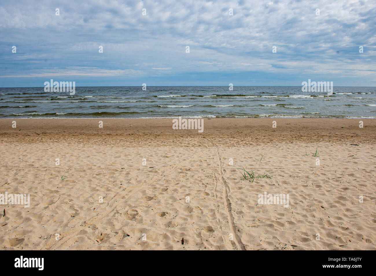empty sea beach in summer with waves and broken clouds. white sand ...