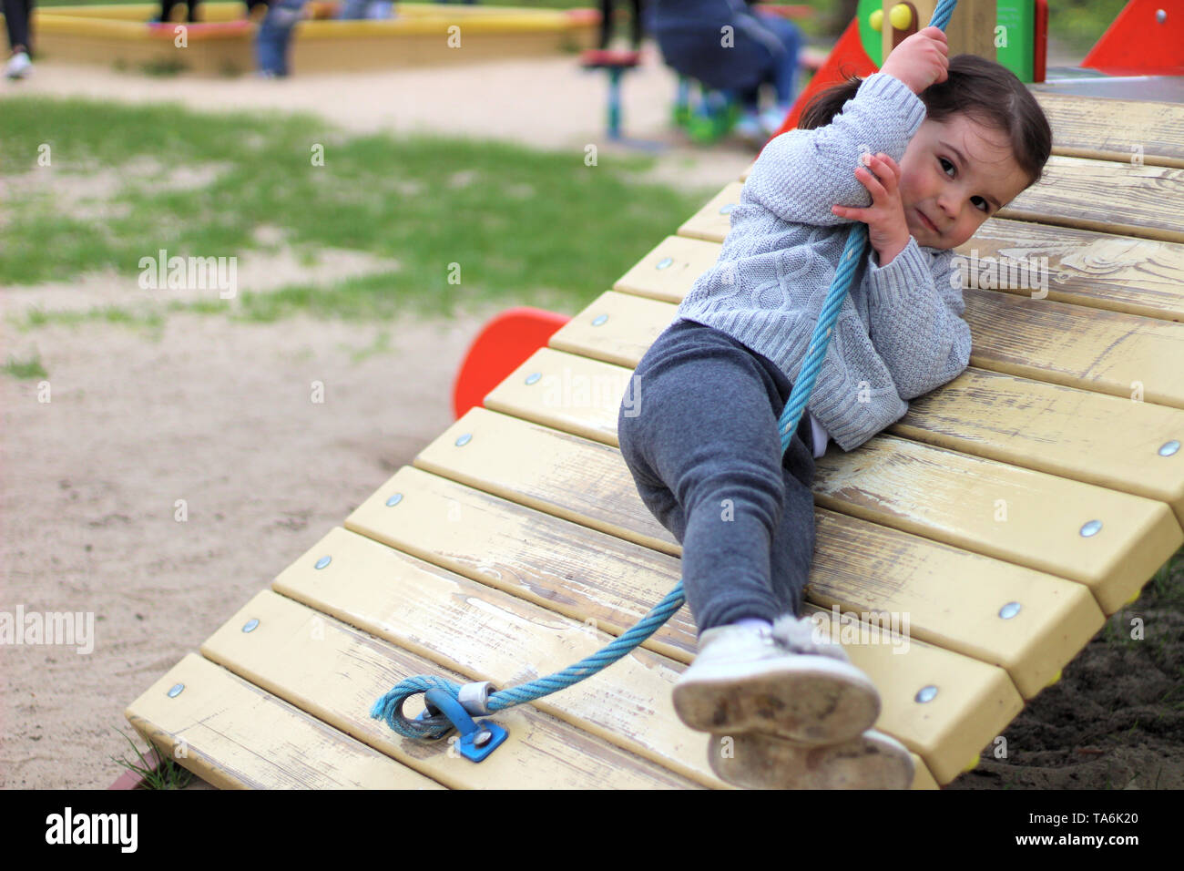 a child is climbing a tightrope in the playground Stock Photo - Alamy