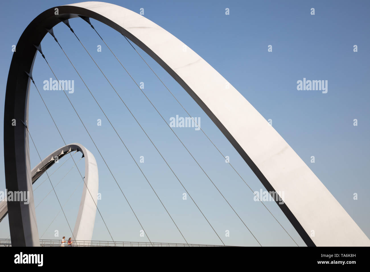 Elegant white curves spanning over the new pedestrian bridge in the ...