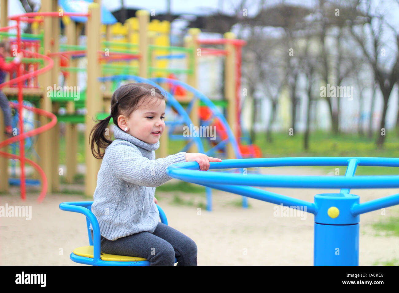 child rides on the carousel in the playground Stock Photo - Alamy