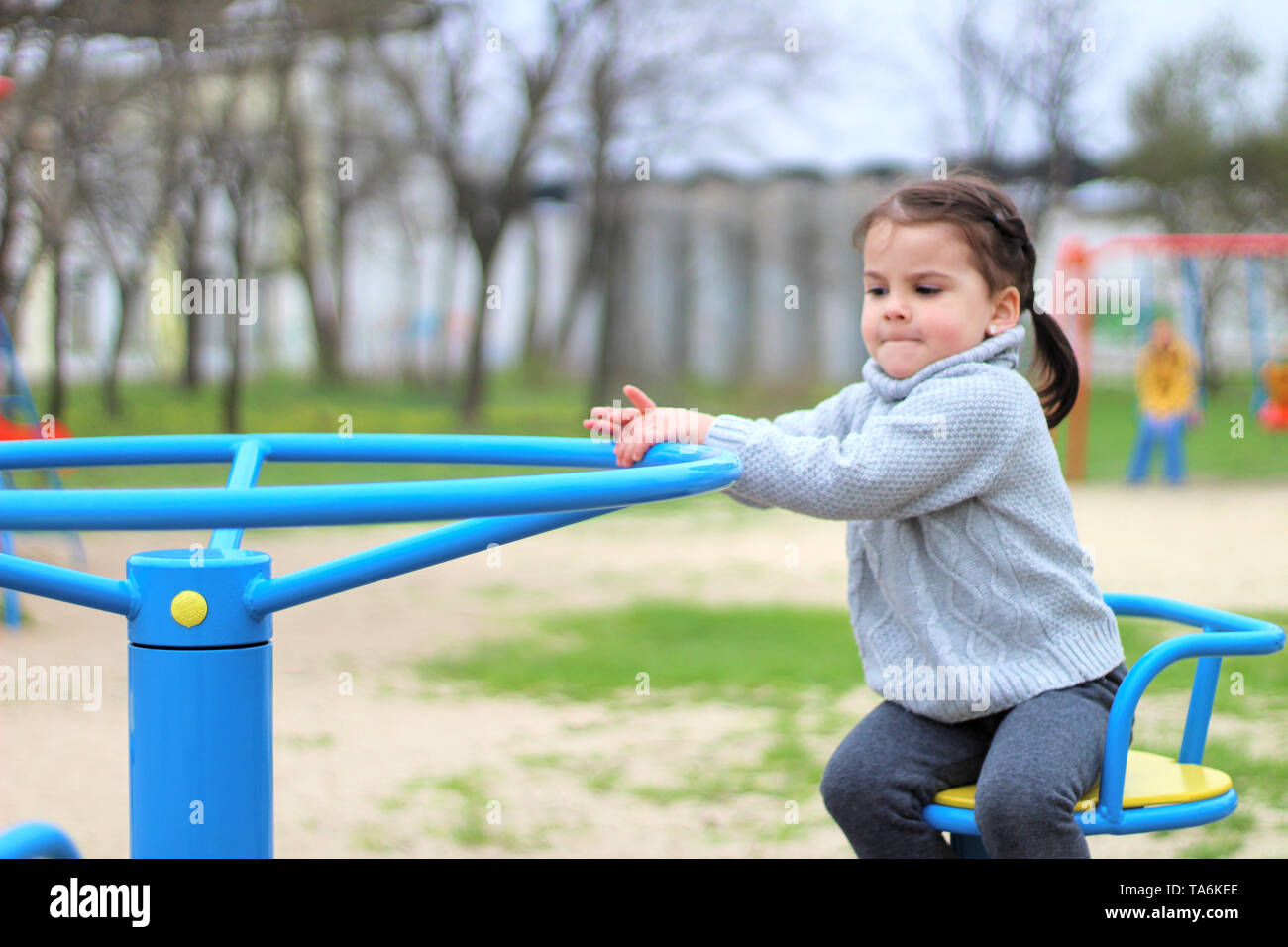 child rides on the carousel in the playground Stock Photo - Alamy
