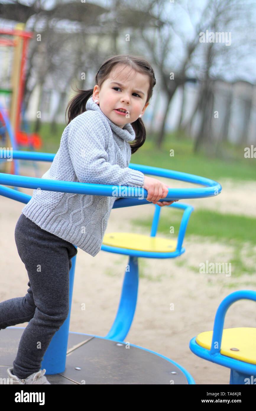 child rides on the carousel in the playground Stock Photo - Alamy