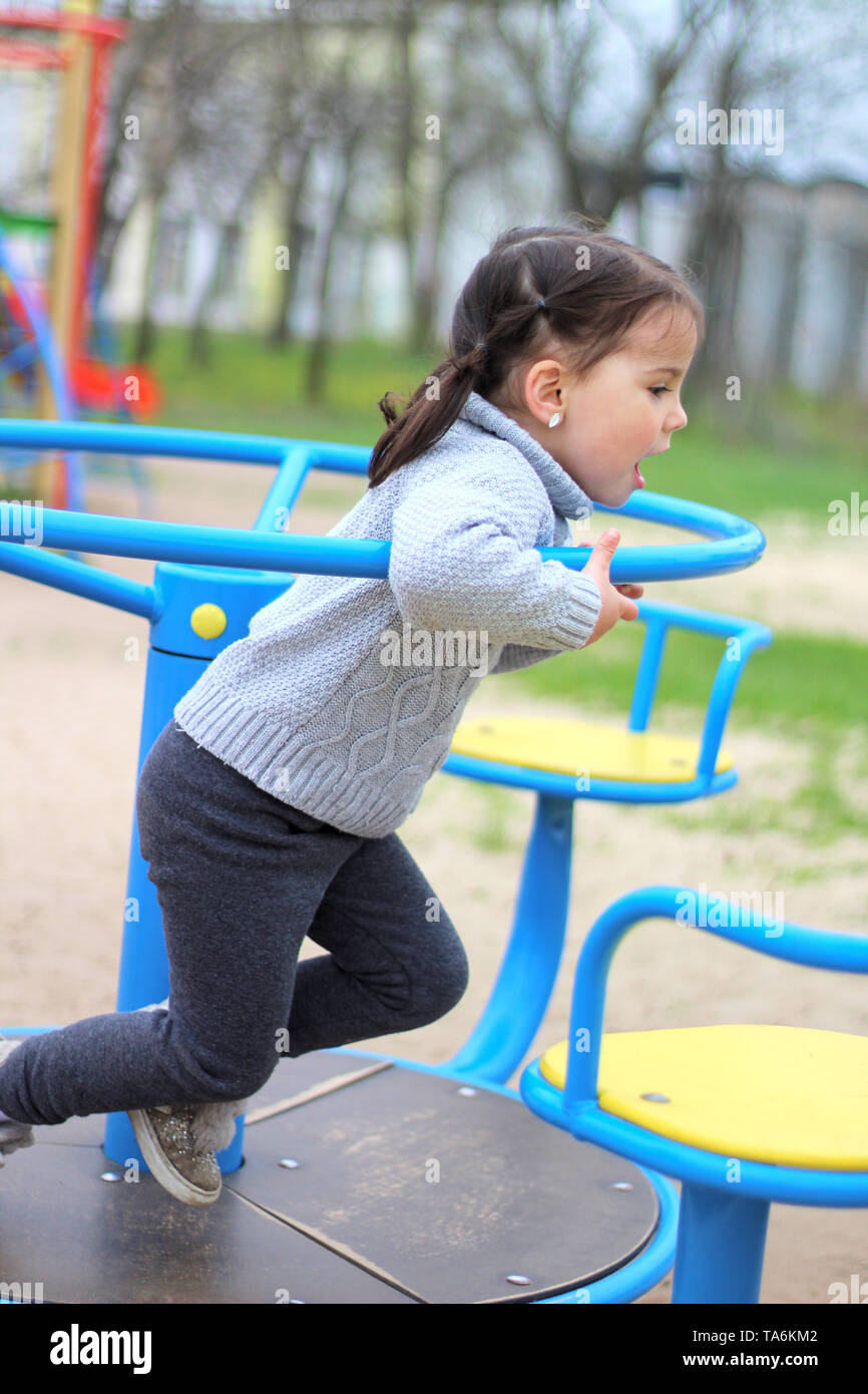 child rides on the carousel in the playground Stock Photo - Alamy