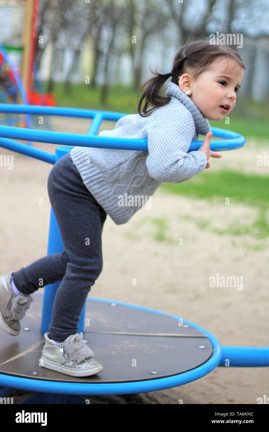 child rides on the carousel in the playground Stock Photo - Alamy