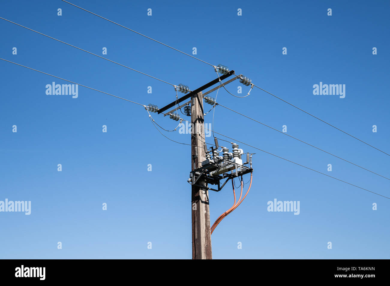 Electrical pylon with high voltage transformer against blue sky Stock ...