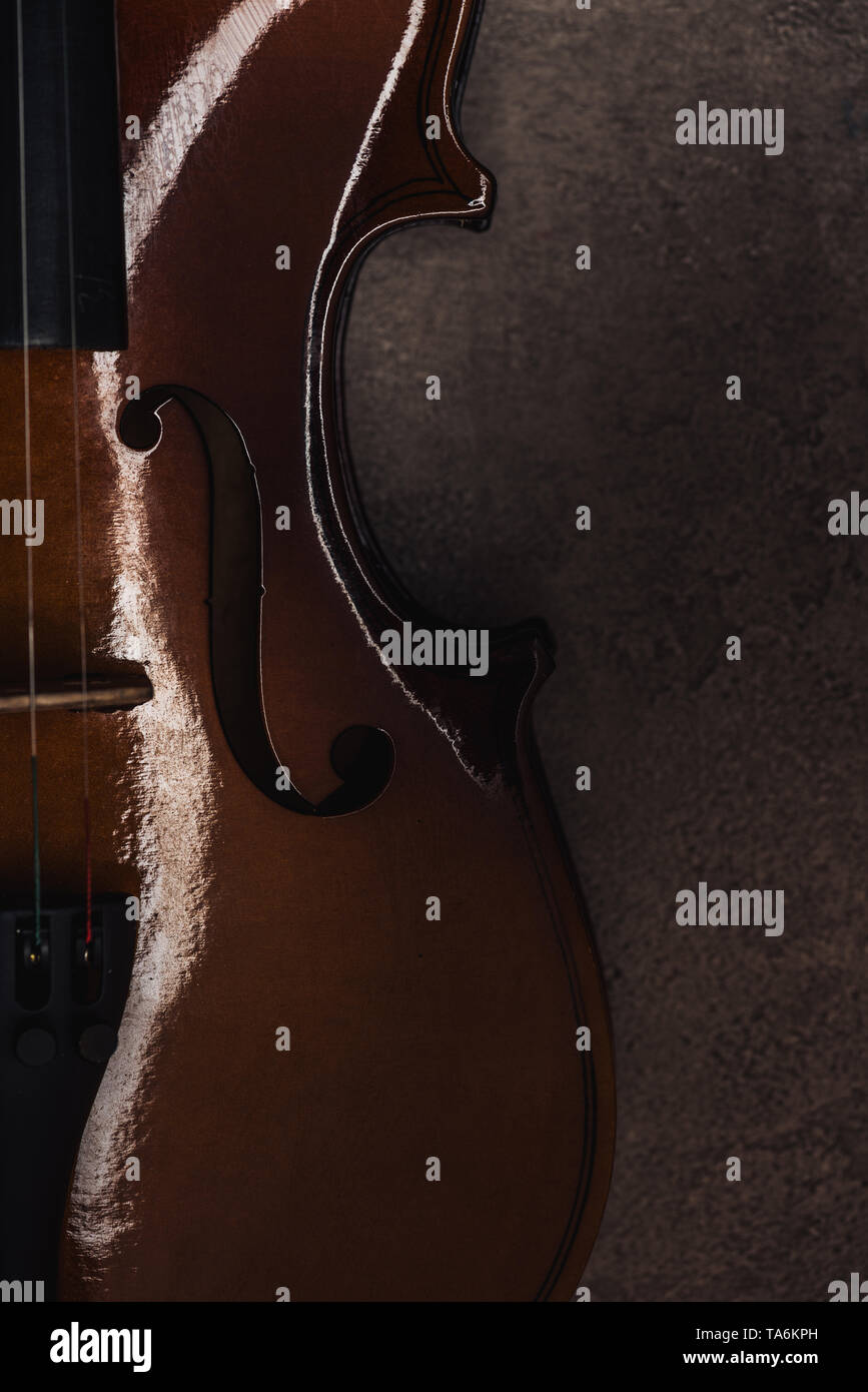 top view of classical cello on grey textured surface in darkness Stock ...